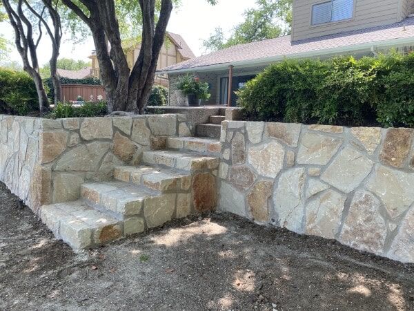 Replaced old crosstie wall with Millsap stone wall in Richardson, Texas